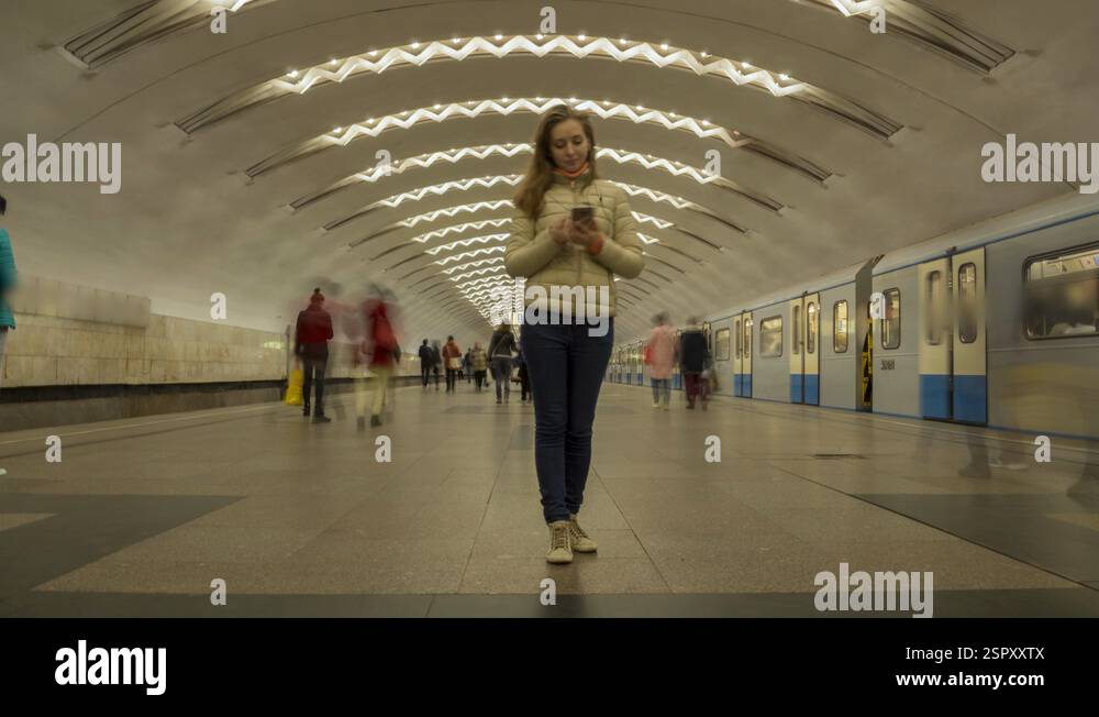 Woman Standing Still in Metro Station and Using Mobile Phone. Crowd of ...