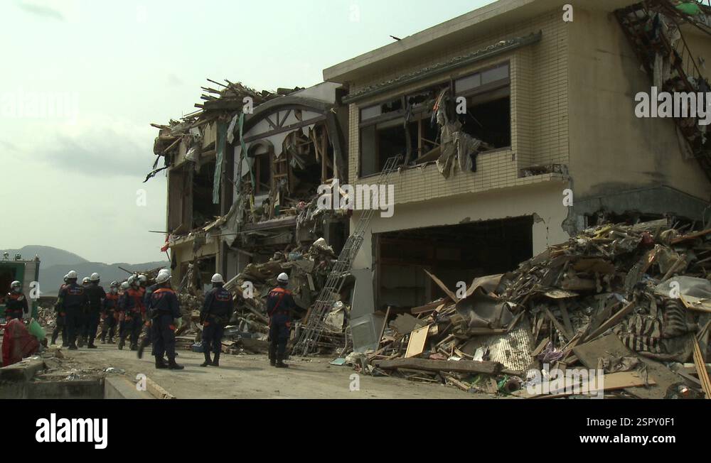Japan Tsunami Aftermath - Rescue Team Outside Destroyed Building Stock ...