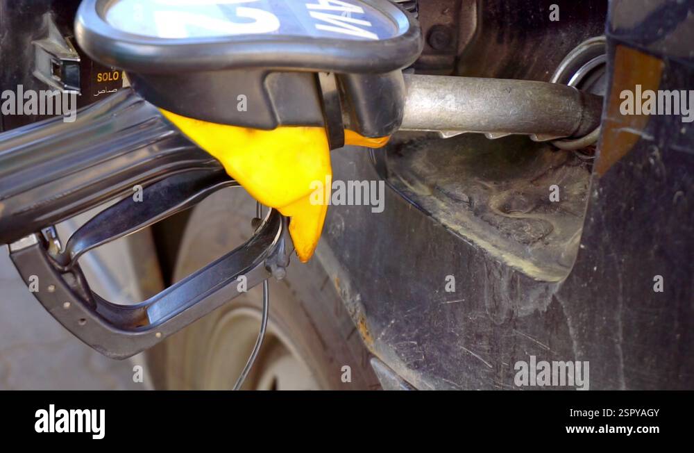 Car on petrol station.refueling pistol and open fuel tank close-up ...