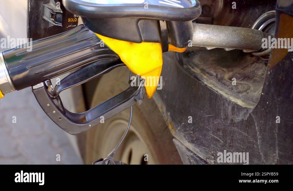 Car on petrol station.refueling pistol and open fuel tank close-up ...
