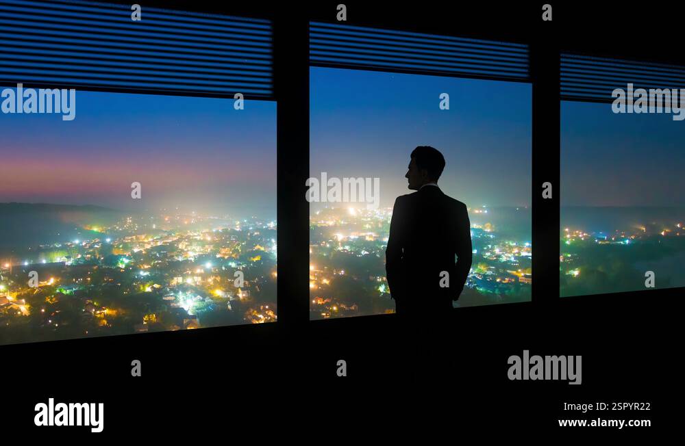 The man stand near a window on the night city background. time lapse ...