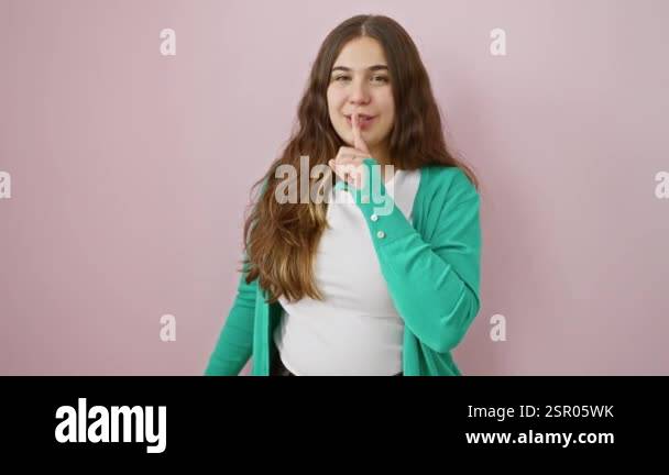 Shush! beautiful young hispanic woman confidently stands in silence ...