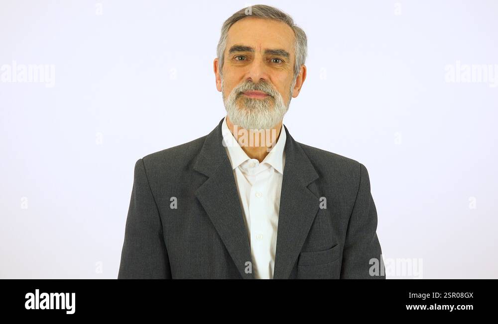 An elderly man applauds and smiles at the camera - white screen studio ...