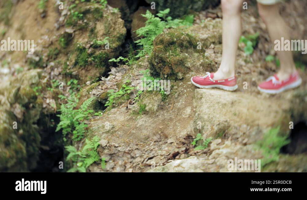 foot steps of hiker hiking outdoors. walking feet on rocky terrain ...