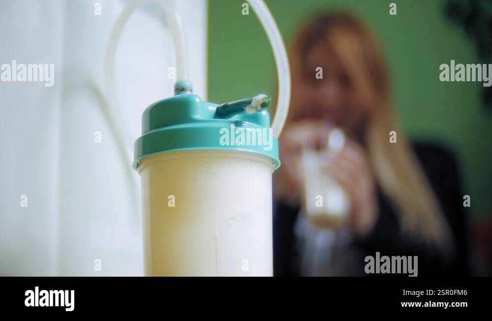 A woman drinks an oxygen cocktail with a device for oxygen scum. Oxygen ...