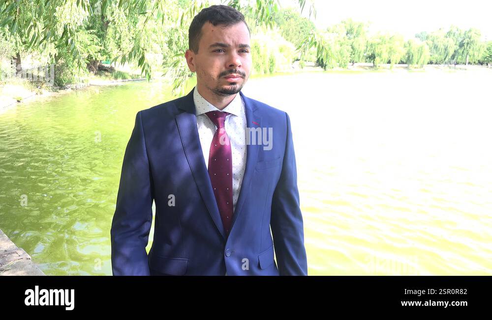 Frowned banker stressed career employee suit and tie thinking alone in ...