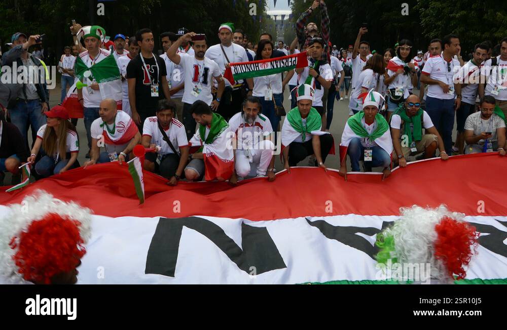 Iranian crowd of fans in street waving a big giant flag dancing ...