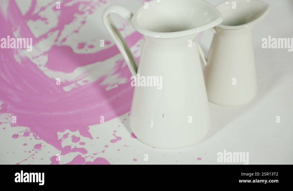 two iron jugs with acrylic paint stand Stock Video Footage - Alamy