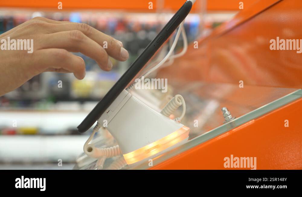 The buyer in the electronics store chooses a new gadget. 4k, close-up ...