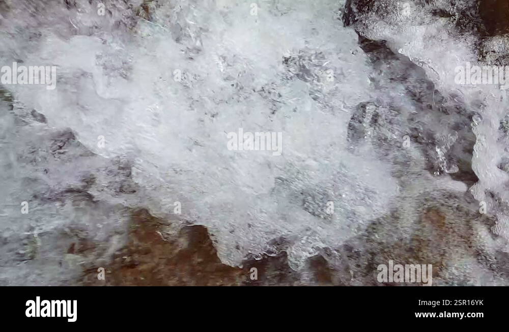 Background or texture. Slow motion of a small mountain waterfall ...