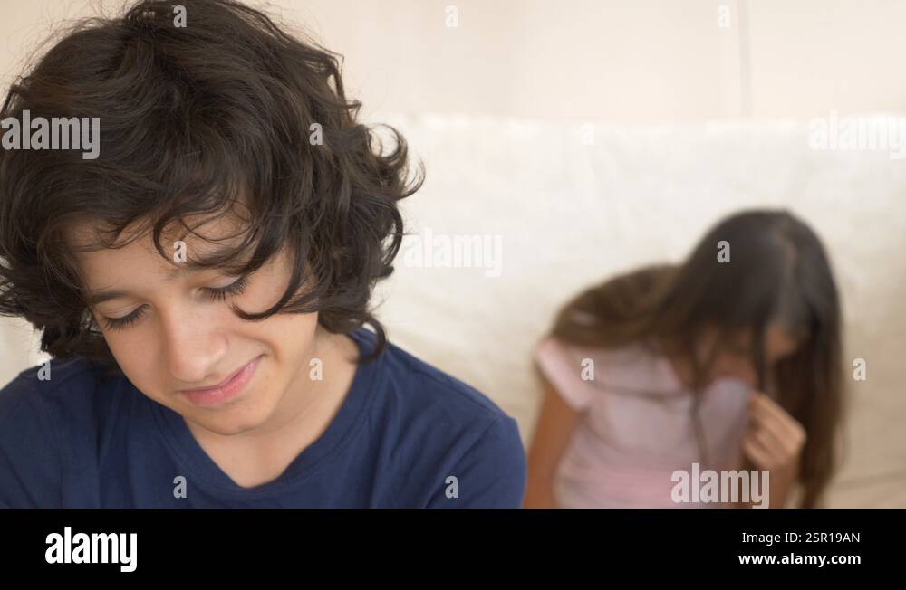 teenagers, twins, brother and sister quarrel, sitting on the couch. 4k ...