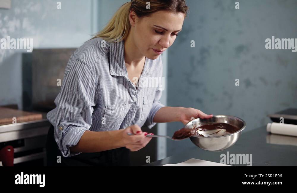 Young woman pastry chef making dessert in her own kitchen. Filling baked tartles Stock Video ...