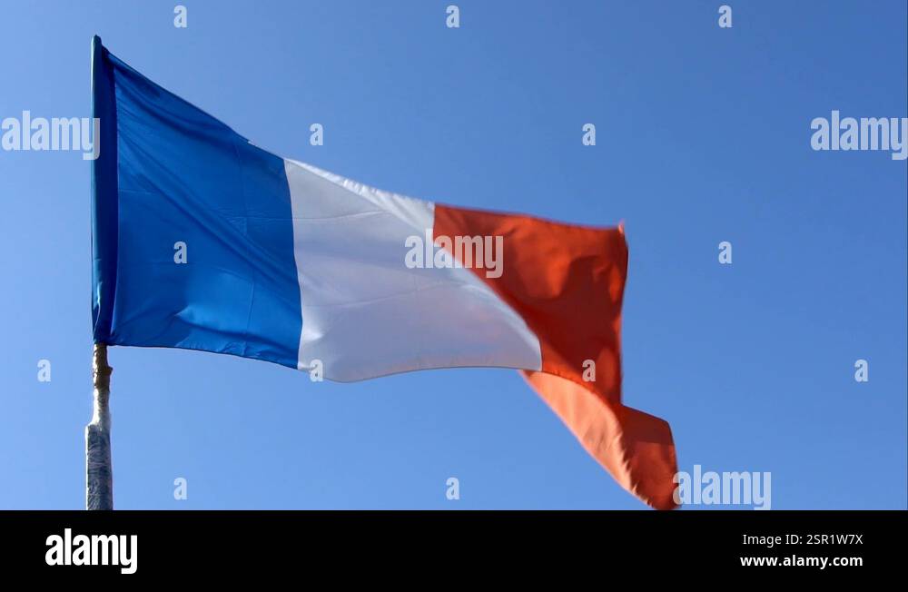 Slow motion of French flag waving in the wind on flagpole at an France ...