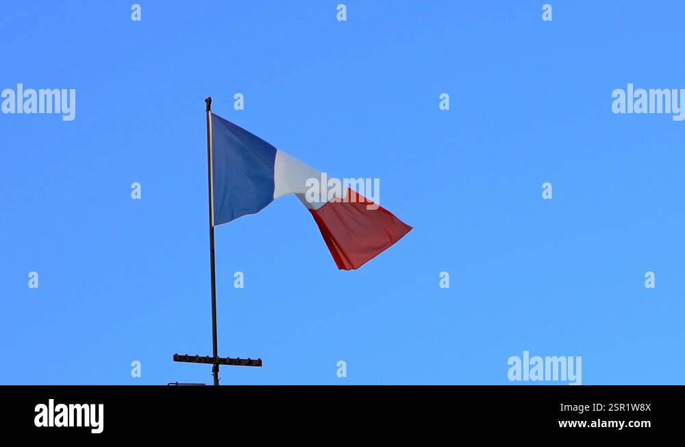 Slow motion of French flag waving in the wind on flagpole at an France ...