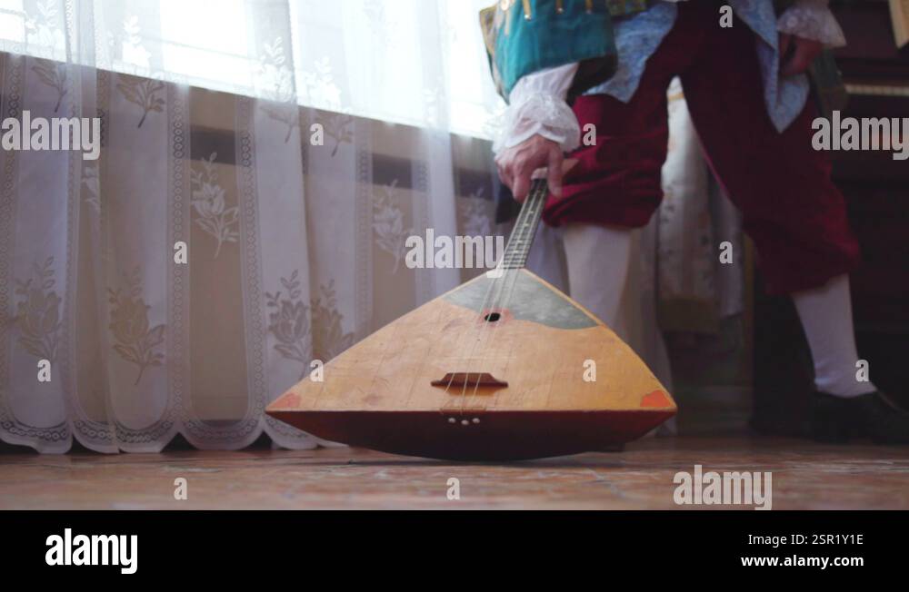 Balalaika wooden in the hands of the musician. Stock. Folk musical art ...