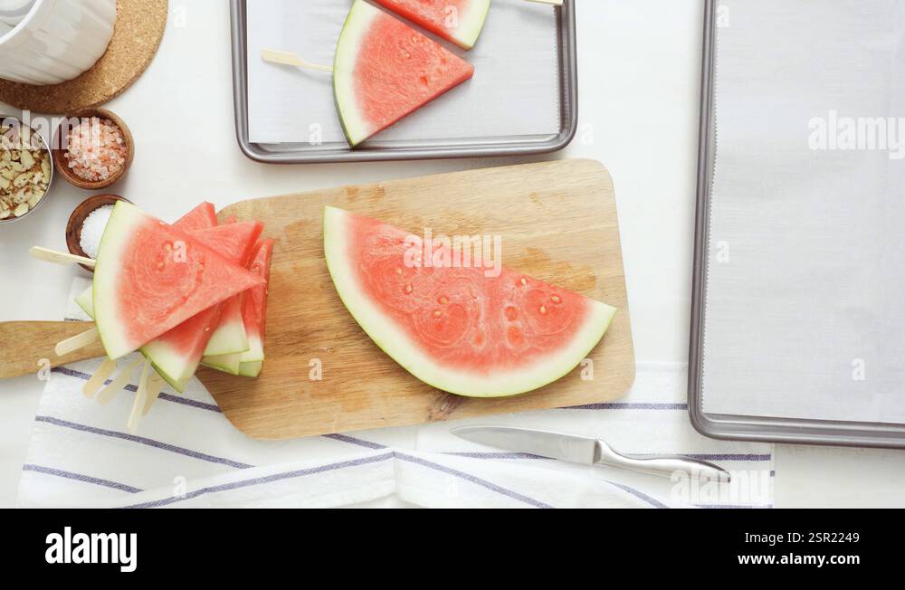 Slicing watermelon into wadges to make watermelon ice pops Stock Video ...