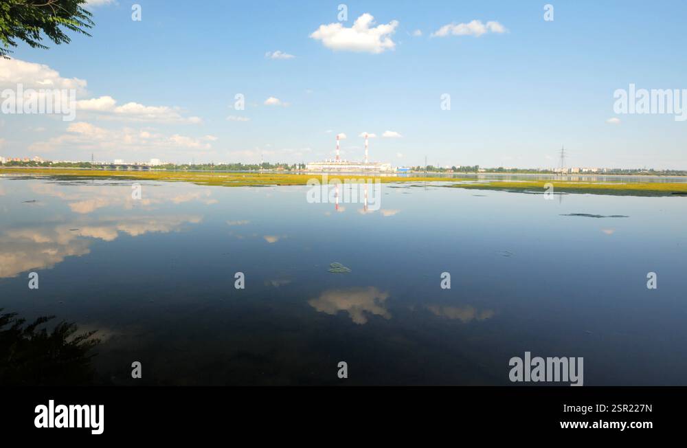 Electric station and large water pond with reflecting clouds Stock ...