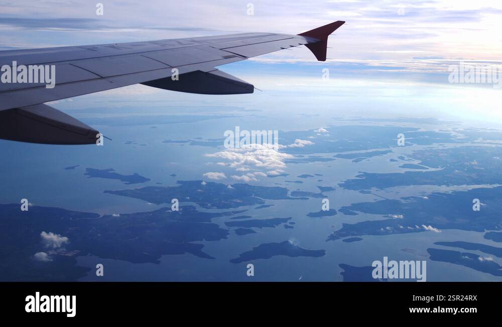 Wing of an airplane flying above the clouds with sunset sky. Aircraft ...