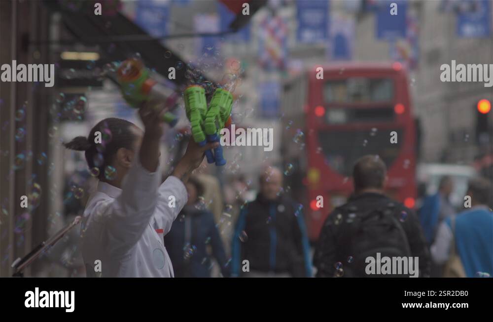 Blowing Bubbles and conducting unseen orchestra in busy city street ...