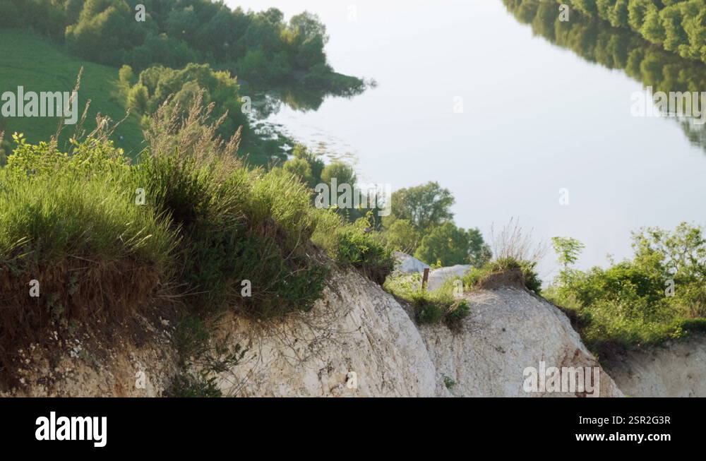 Spring landscape. Top view of river surrounded by a green forest and ...