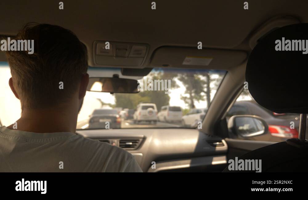 car jam on a busy road in a bright sunny day, view from the car, blur ...