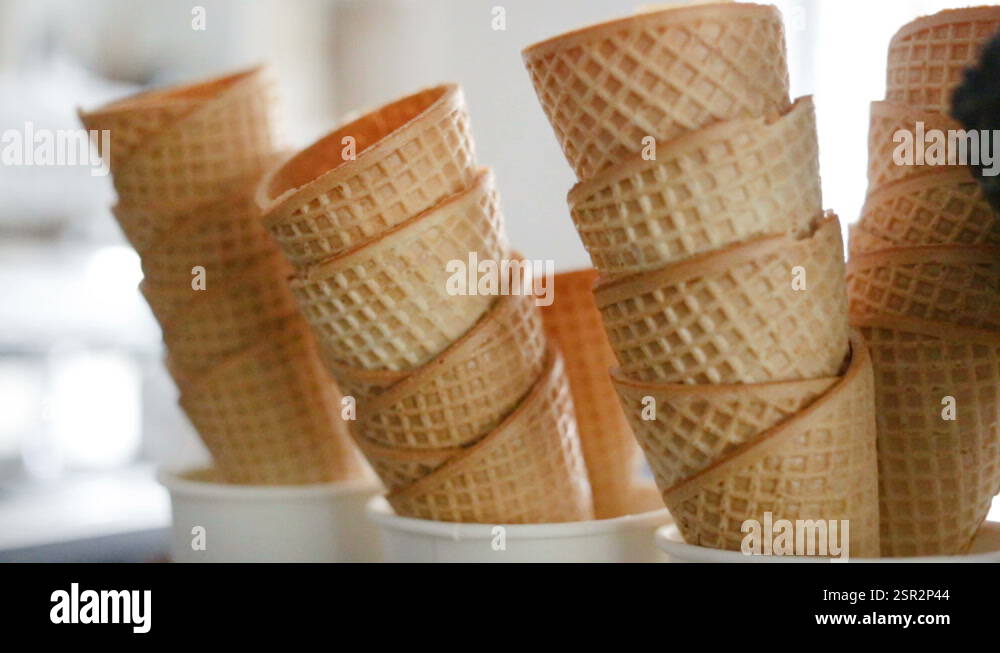 Empty fried waffle cones are stacked in each other. Real time, indoors ...