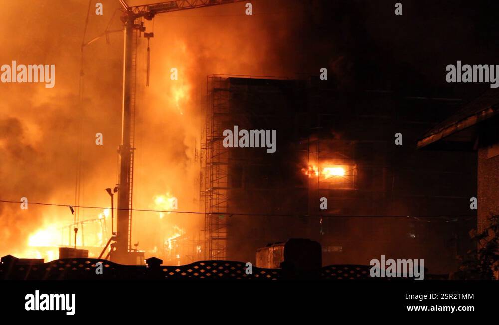 Stunning fiery inferno at night shows flames ripping out of half-built ...