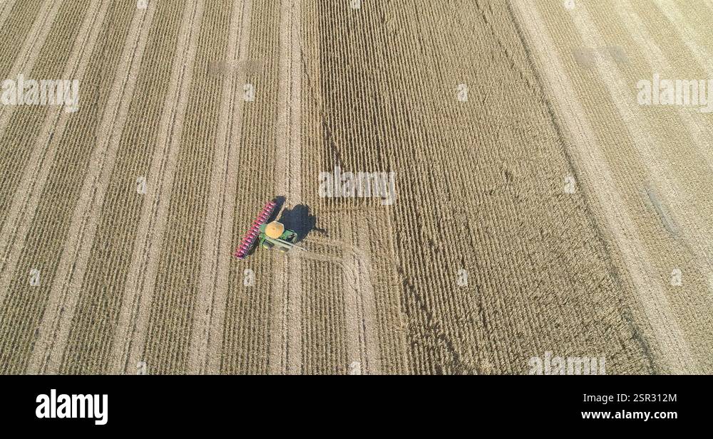 Combine making its way from harvesting its crop of corn to empty its ...