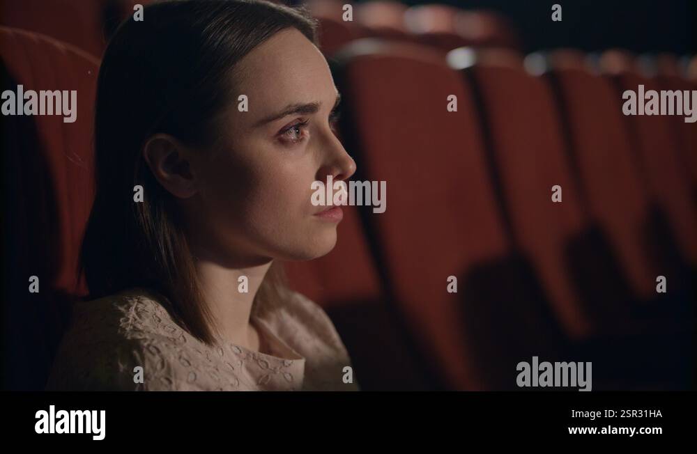 Girl watching sad film at movie theater. Woman crying on melodrama ...