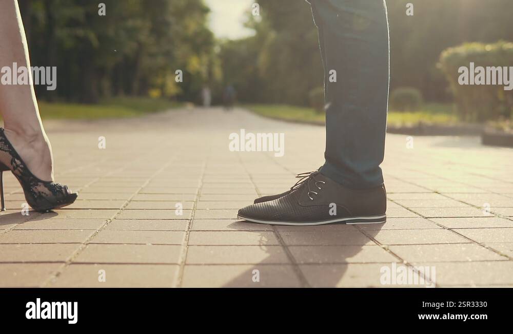 Woman up her toe. Young couple stand at city and kiss each other Stock ...