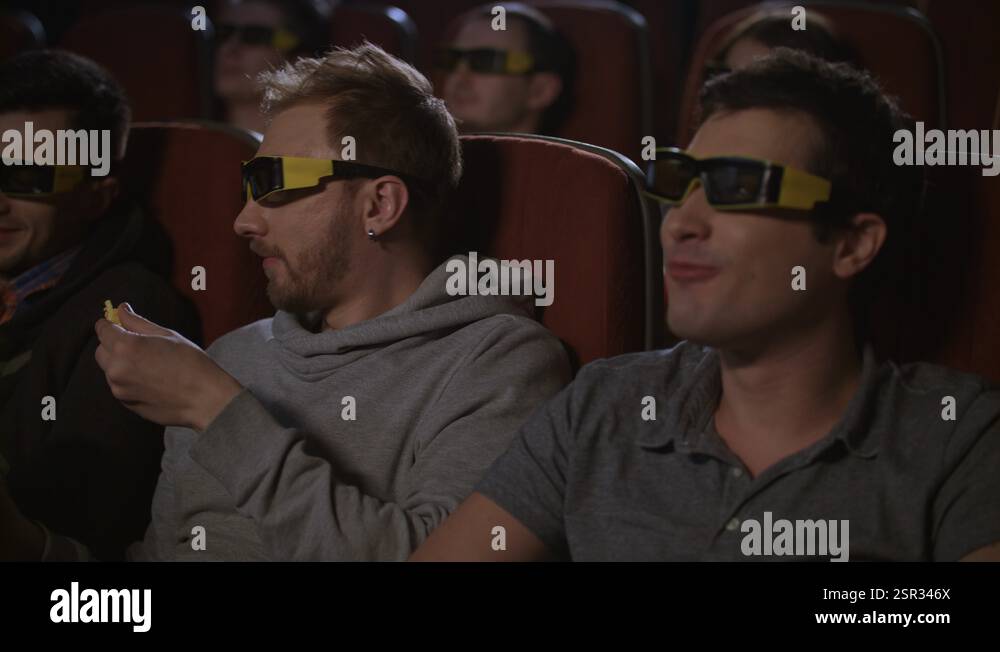 Man friends eating popcorn at 3d cinema movie. Men have fun at cinema ...