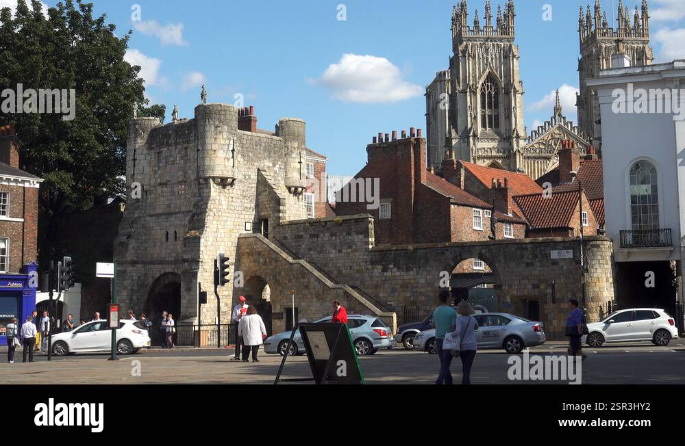 Bootham Bar gate in the city walls and the towers of the Minster in ...