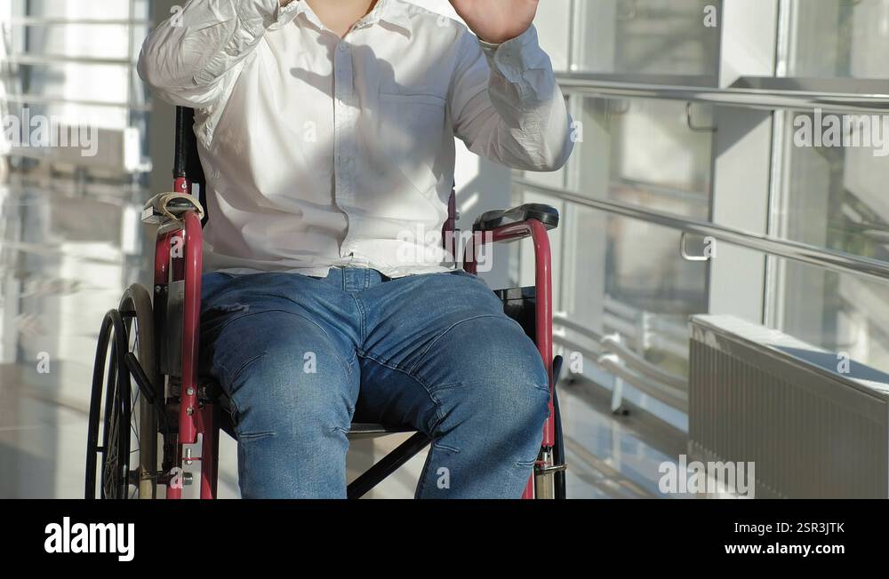 disabled man on a wheelchair at a window uses a helmet of virtual ...