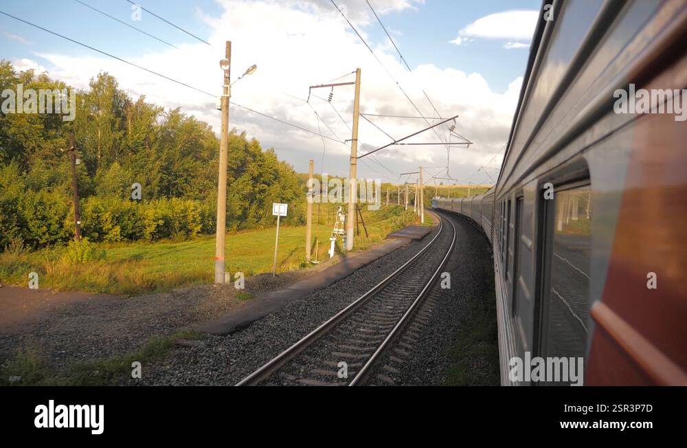 Railroad cars outside train ride on rails near the forest railway. slow ...