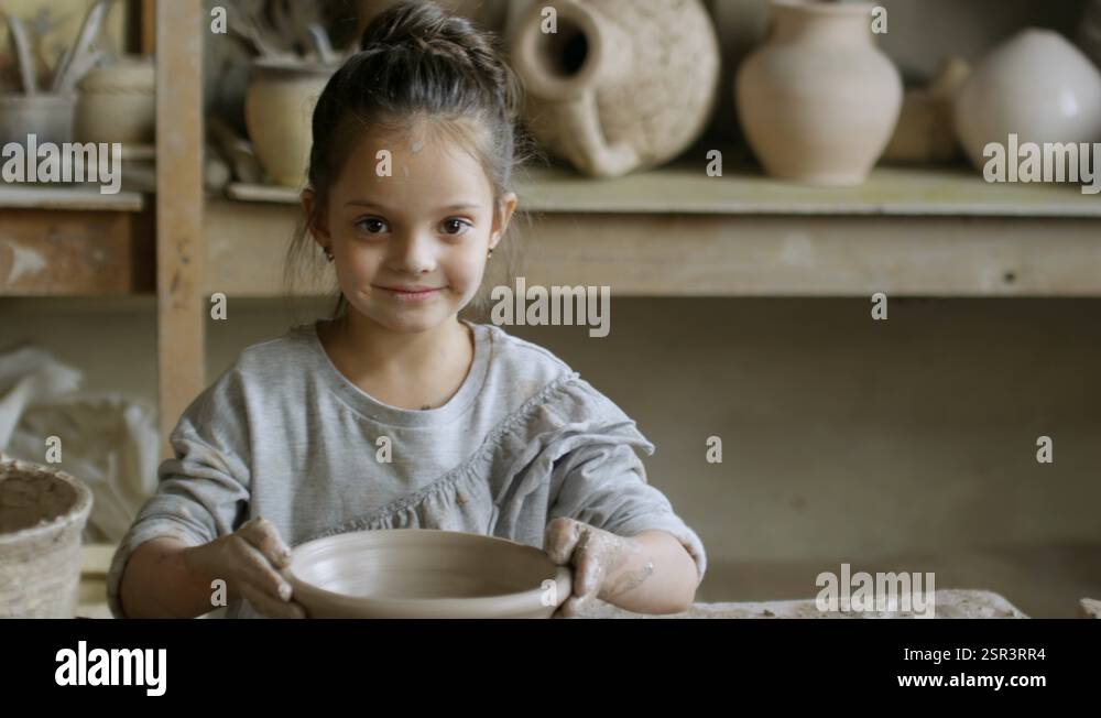 Cute Little Girl Making Pottery and Posing Stock Video Footage - Alamy