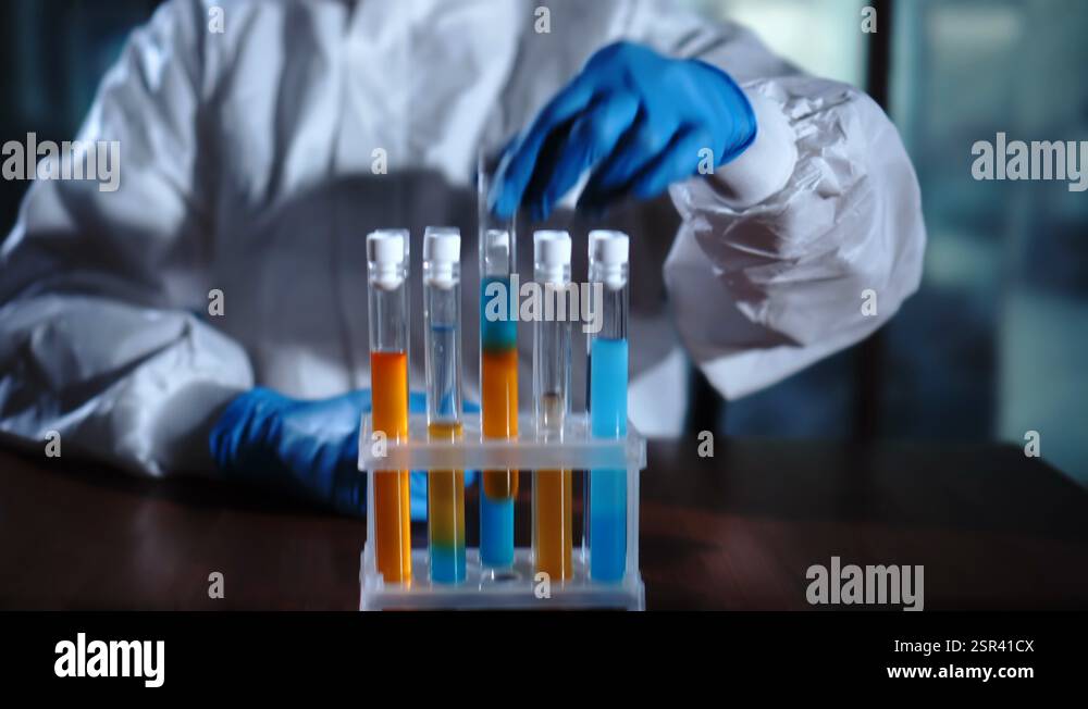 Scientist in the laboratory examines a test tube. New technology, cure ...