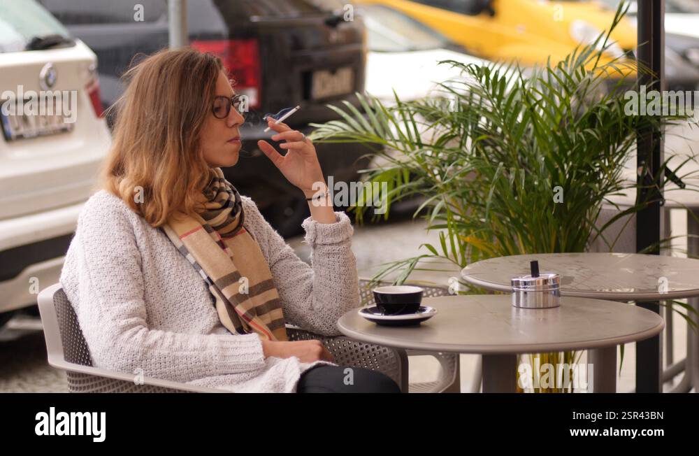 ==5 Woman sit smoking cigarette at the street cafe table while drinking ...