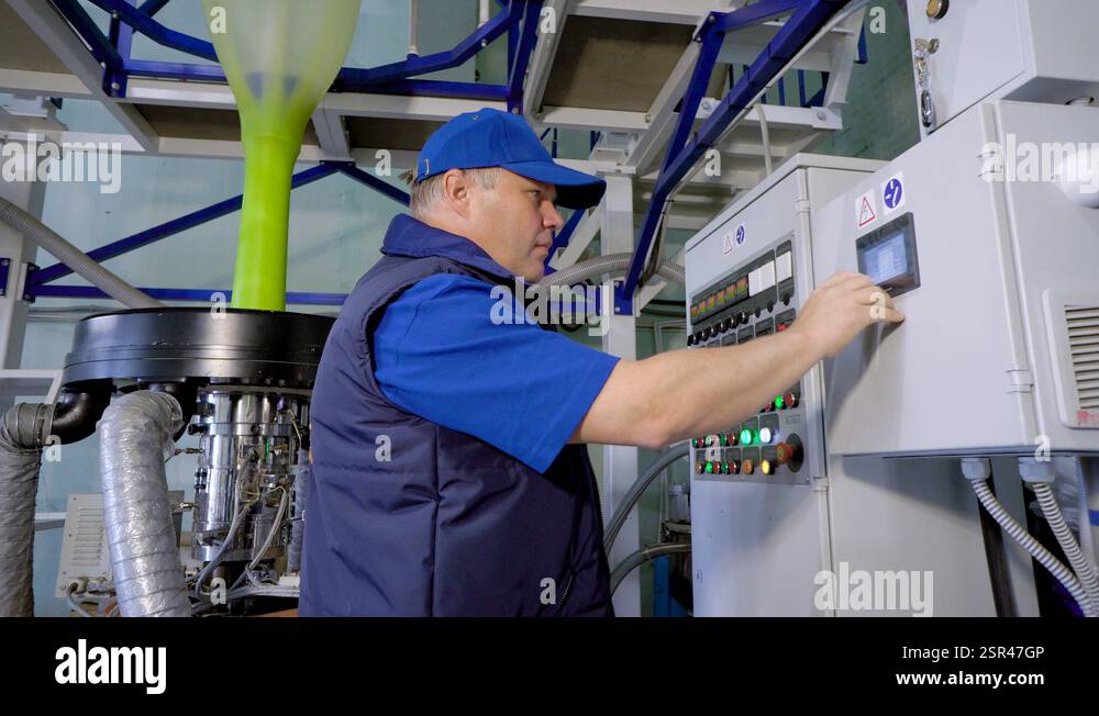 Worker checking and set up LDPE Plastic Blown film bag making machine ...