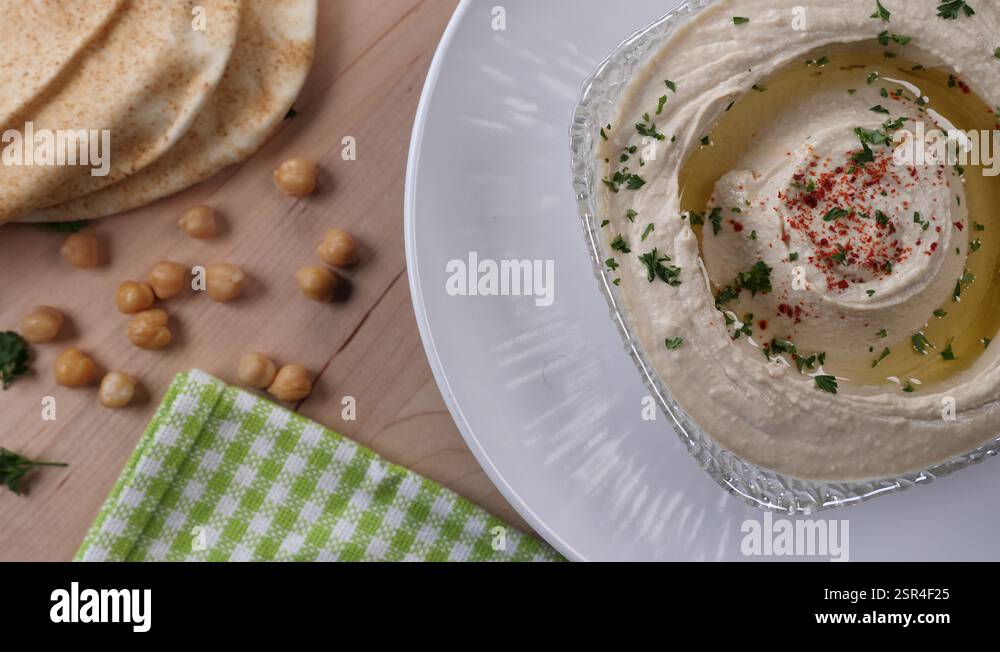Hummus plate preparation with chickpeas and parsley and paprika and ...