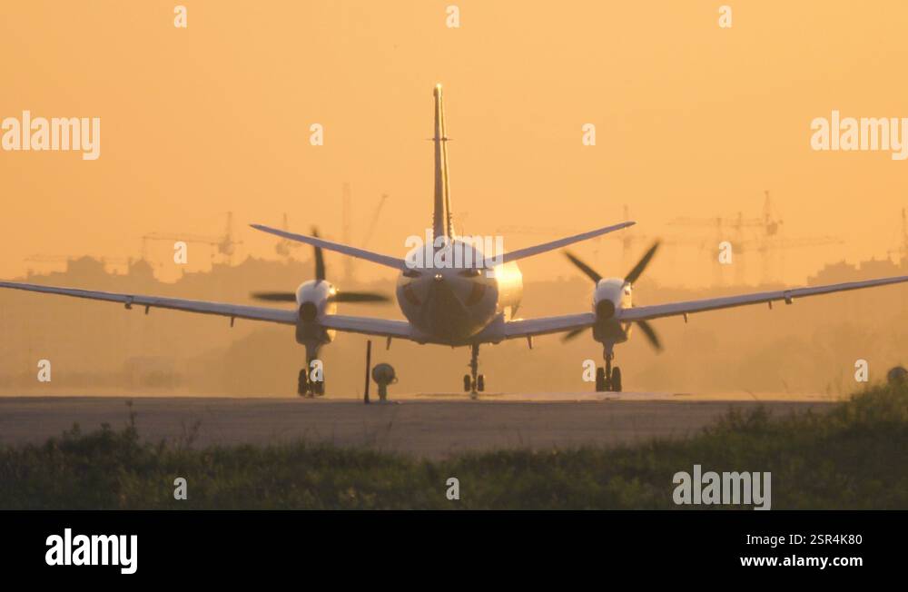 Propeller plane with running engines accelerations on the runway before ...