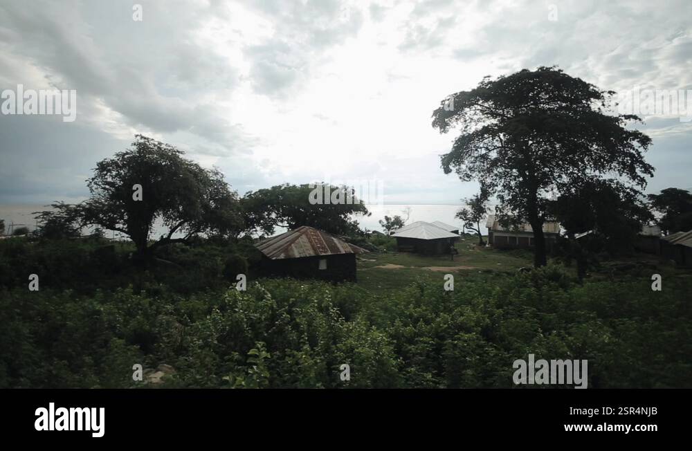 Beautiful landscape of a poor village in Africa. Small houses stand on ...