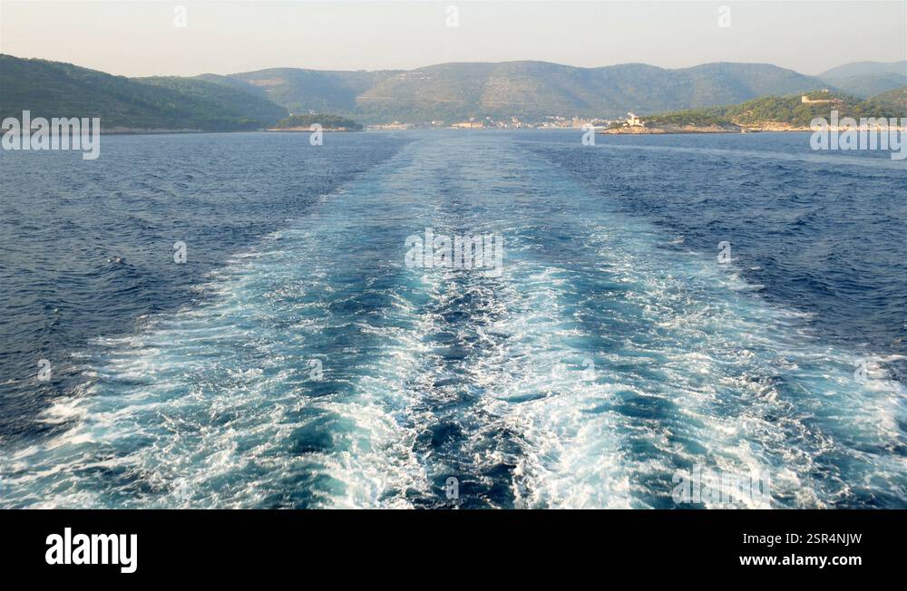Boat wake on blue sea with island at background 4K Stock Video Footage ...