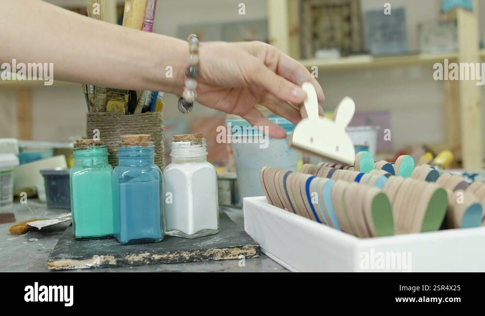 Hands of fingering the jar and bottles of paint, picking the right ... Hands of fingering the jar and bottles of paint, picking the right ...