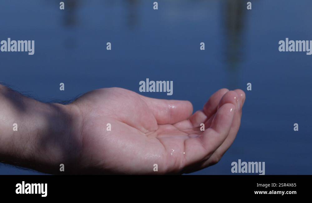 Slow motion hand dripping fresh water connection to nature Stock Video Footage - Alamy