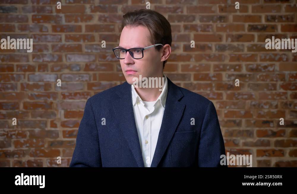 Bingo sign of caucasian man in dark suit, glasses, office appearance ...