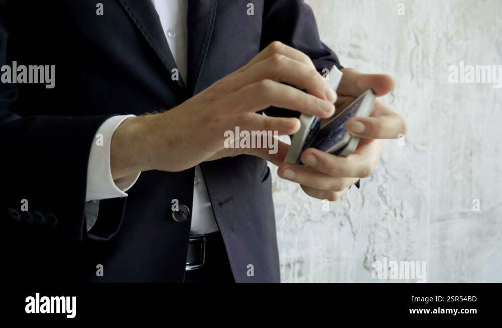 Magician's hands shuffling deck of cards, performing card trick. Slow ...