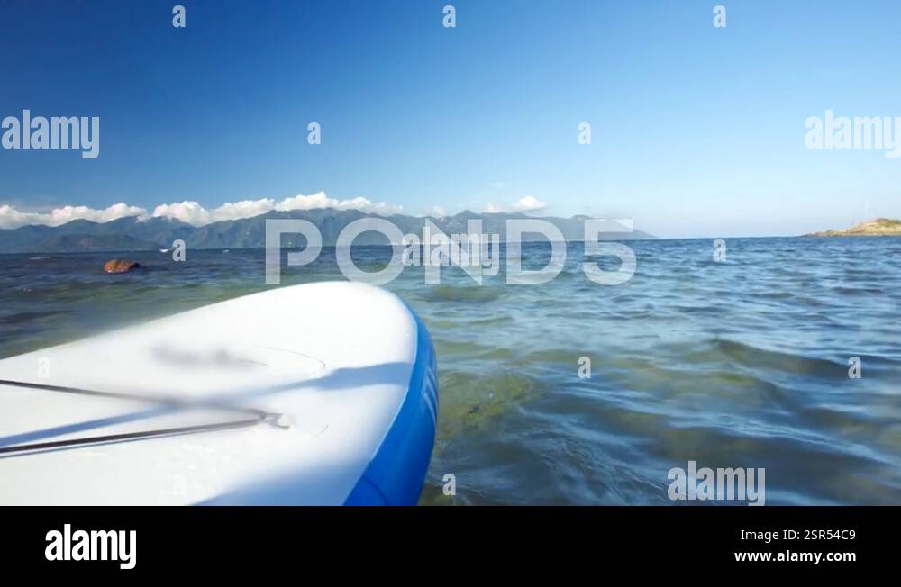 modern paddleboard and girl in bikini floats back view Stock Video ...