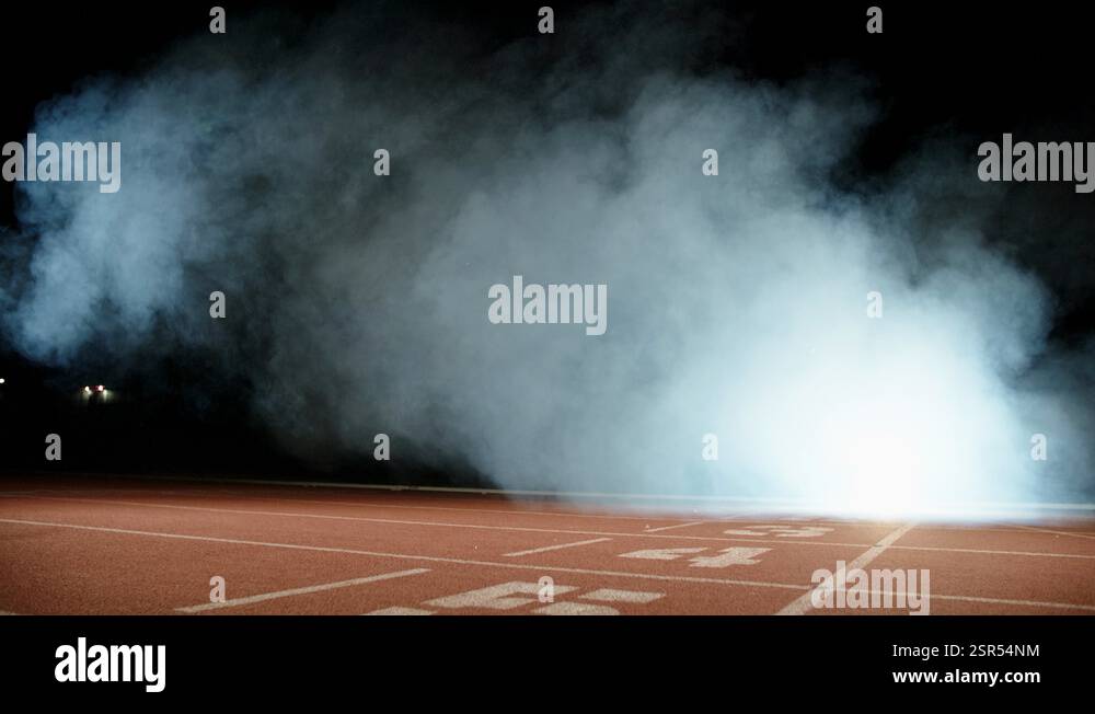 Runner heading forward. Young female athlete blasting off in smoke on ...