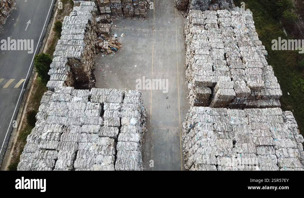 Compacted recyclable plastic waste at a recycling plant. aerial view ...