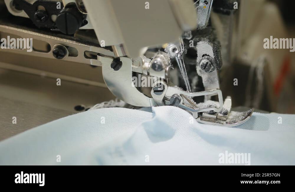Woman's hands sewing an overlock at sewing machine. Overlock stitch on ...